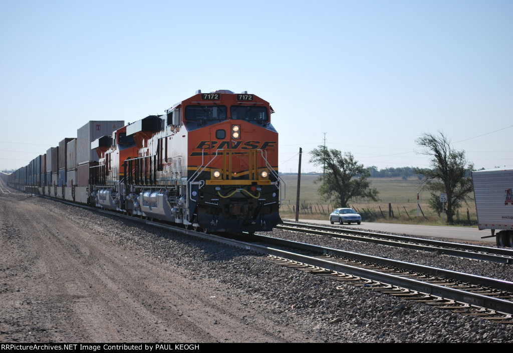 Almost up to me at the Eastern Road Railroad Crossing with 3rd Ave on the right BNSF 7172 and ...